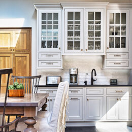 Beaded Inset Cabinets with Brick Backsplash in Kitchen