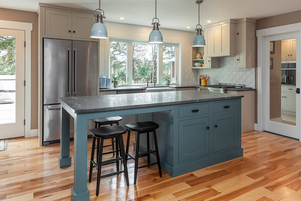 Framed Inset Cabinets Surround the Teal Kitchen Island
