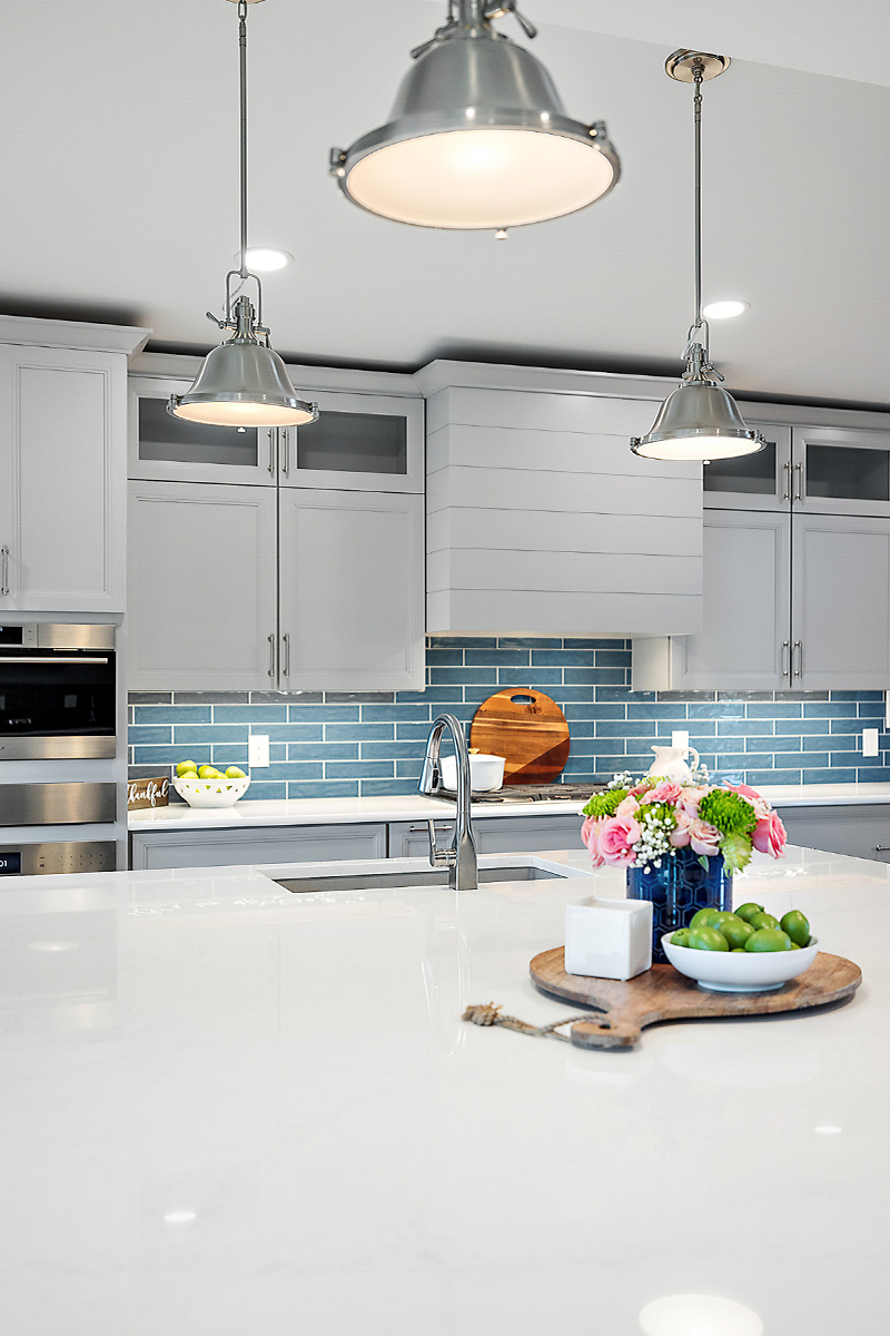 Spacious Kitchen Island Accompanies Blue Kitchen Backsplash